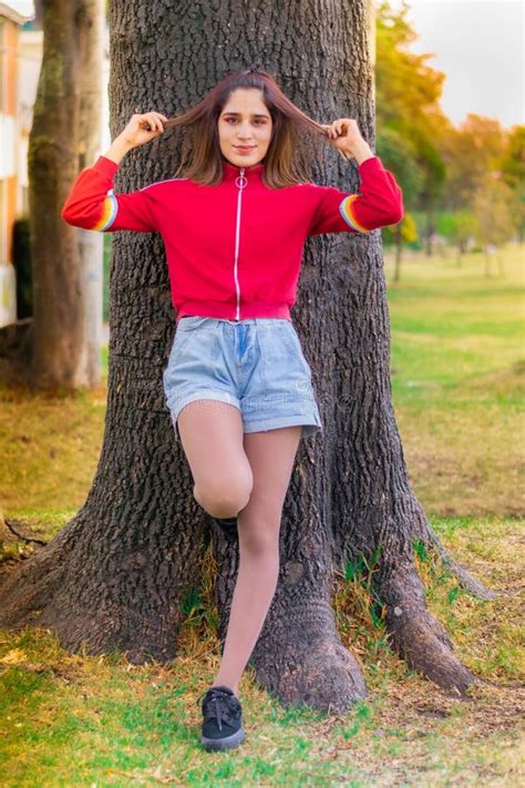 Teenage Colombian Woman Enjoying A Sunny Afternoon In The City Park
