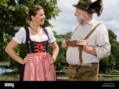 A Traditionally Clothed German Man And Woman In A Beer Garden Stock