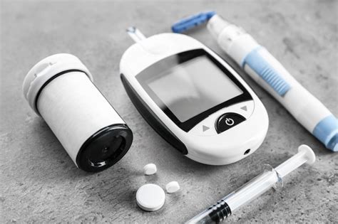 Digital Glucometer Lancet Pen Syringe And Medicaments On Grey
