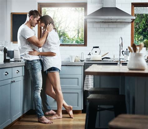 Hug Love Or Happy Couple In Kitchen For Romance Care Or Bonding Together With An Intimate