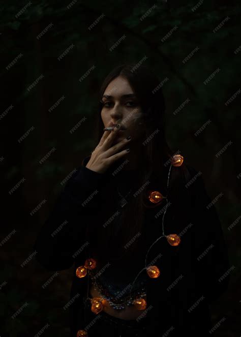 Premium Photo Portrait Of Young Woman Smoking In Dark