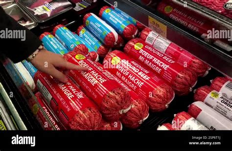 Woman Selecting Medium Ground Beef Inside Walmart Store At Meat