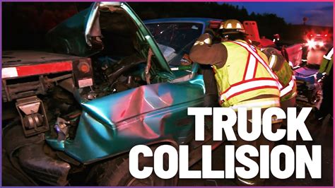 Firefighters Rush To Rescue A Car Crash Victim From A Mangled Truck