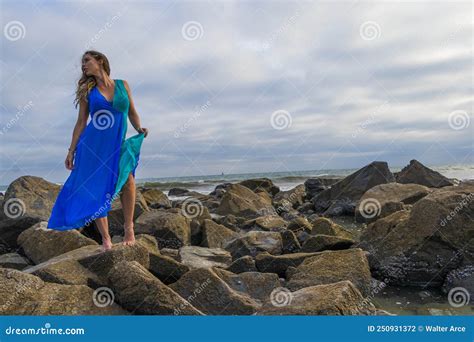 Lovely Brunette Latin Model Poses Outdoors On A Beach At Sunset Stock