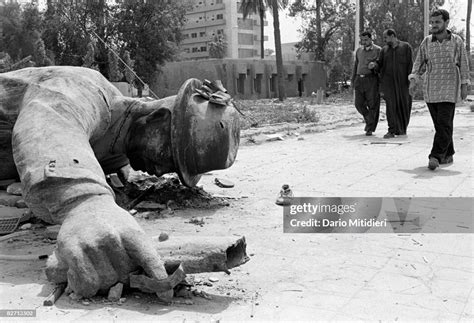 A Statue Of Saddam Hussein Removed From Its Original Location Is Left