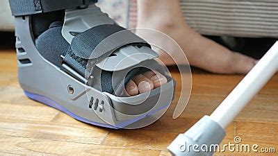 Women Broken Feet With A Grey Plastic Boot Ankle Brace Injury