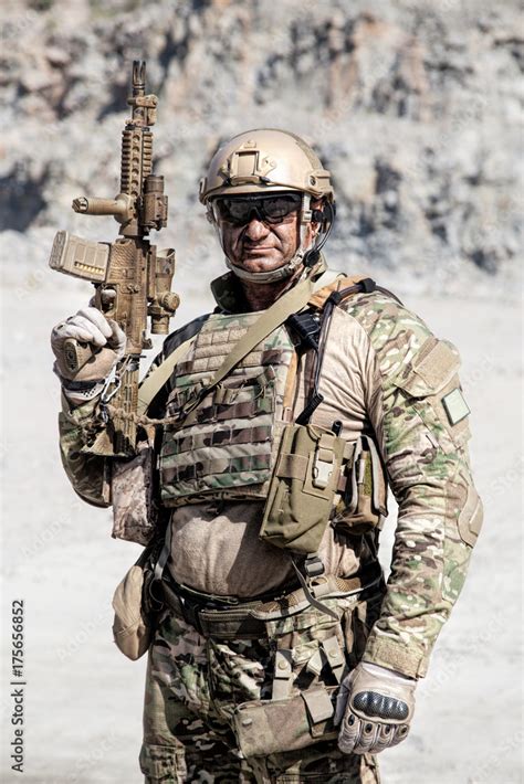 Half Length Location Shot Of Big Muscular Soldier In Field Uniforms