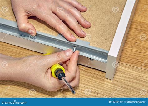 Installation Of The Drawer By Means Of Furniture Hardware Stock Image