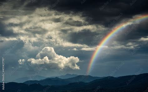 Colorful Rainbow Against Dark Storm Clouds In Background A Natural