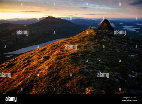 A Hiker Stands Contemplating The Views At The Top Of The Suilven