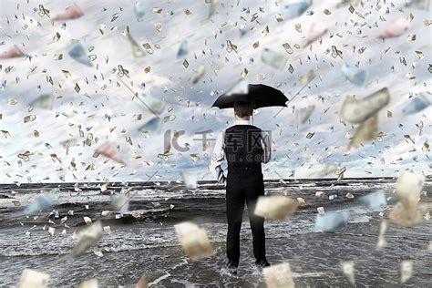 一位年轻的商人撑着伞站在钱雨中高清摄影大图 千库网