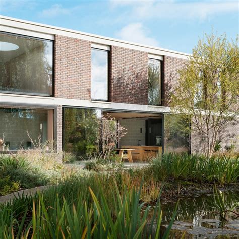 Weathered Timber Cladding Covers Shed Like Field House In Rural England