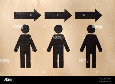 Exit Symbol With Three Human Black Icons With Arrows Above Them On Wood Texture Stock Photo Alamy