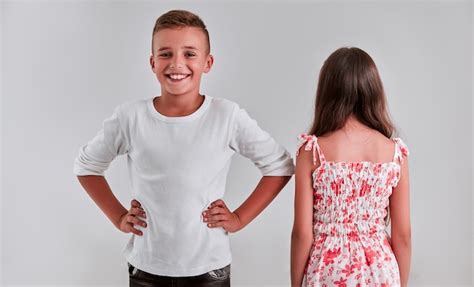 Premium Photo Cute Girl And Boy On A Gray Background The Boy Is