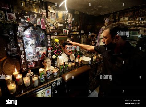 A Man Touches A Statue Of Jesus Malverde Inside A Shrine Dedicated To