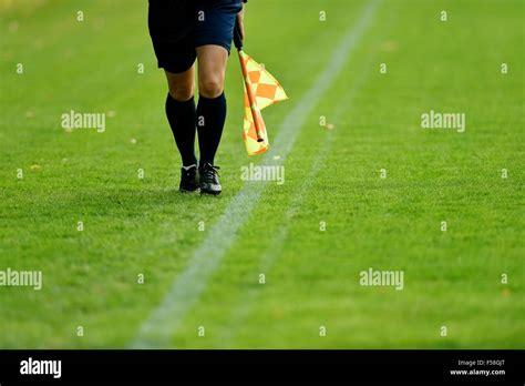 Assistant Referee Running Along The Sideline During A Soccer Match