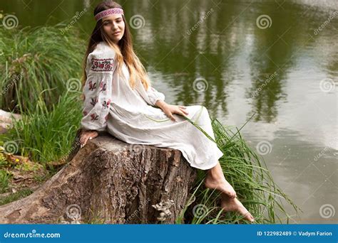 Steep Slender Ukrainian Woman Resting Sitting On A Stump On The Stock Image Image Of Blue