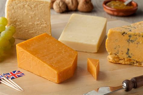 Premium Photo Pieces Of Traditional English Cheese On A Cheeseboard