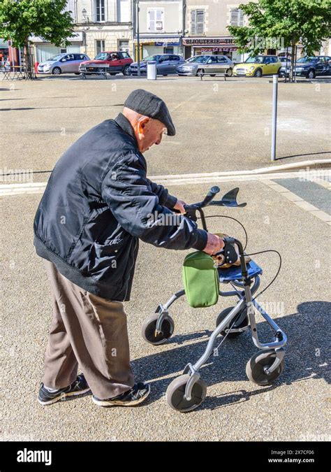 Elderly Man Walking With Mobile Walking Frame For Support Le Blanc
