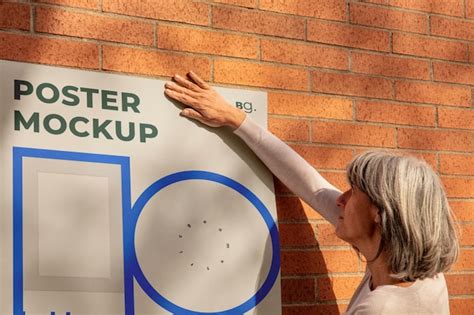 Premium Psd View Of Person Sticking Exterior Poster Mock Up On Wall