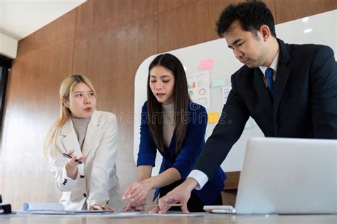 Team Of Professionals Analyzing Financial Reports And Charts During A
