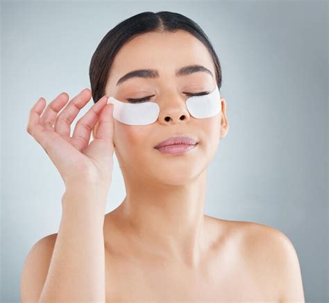 Premium Photo Woman Eye Patch And Hand In Studio For Skincare