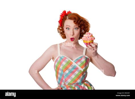 Surprised Retro Fifties Redhead Female With Cupcake Isolated On White
