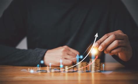 Premium Photo Hand Of Businessman Holding Coin On Stack Of Coins With