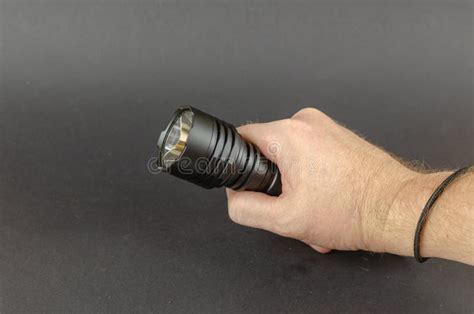 A Man Is Holding A Black Led Hand Flashlight Stock Image Image Of