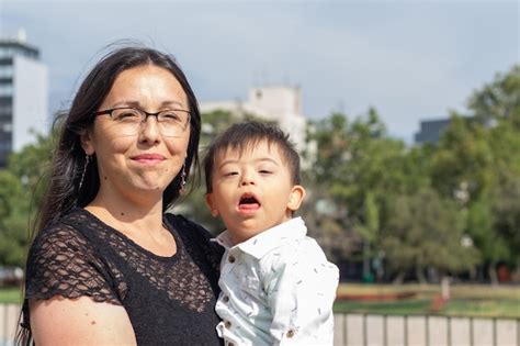 Premium Photo Portrait Of Mother And Her Son With Down Syndrome