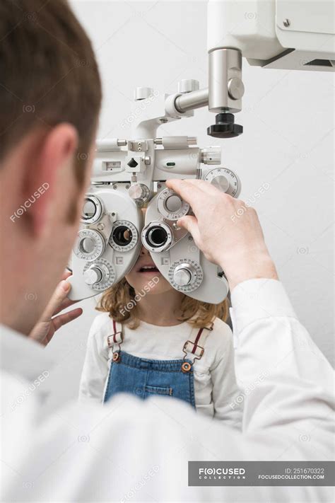 Optician Testing A Girls Eyes With Optometry Devices — Hygienics