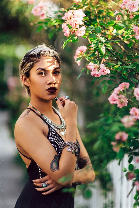 A Beautiful Young Woman Standing By A Rose Bush By Stocksy Contributor Kristen Curette