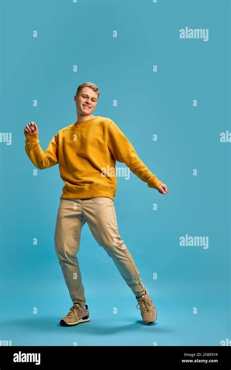 Man Mid Dance Shifting Confidently With Playful Energy Smiling As He Transitions Through