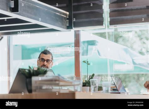 Focused Businessman In A Modern Office Analyzing Statistics Collaborating And Targeting