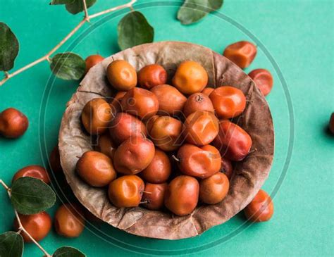 Image Of Female Holding Indian Jujube Or Ber Or Berry Also Known As
