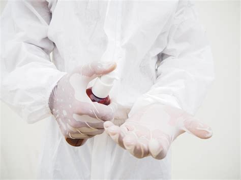 Portrait Of Doctor Or Scientist In Ppe Suite Uniform Holding Plastic Bottle With Skin Care