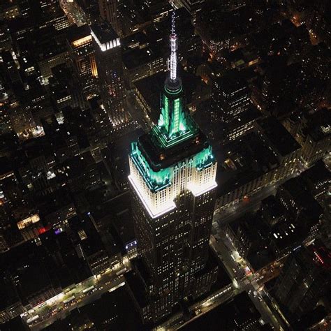 Empire Building In New York City At Night With Green Lights
