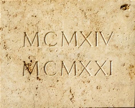 Roman Numerals Mcmxiv And Mcmxxi Engraved In White Stone Translation