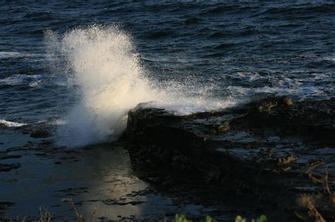 Premium Photo Waves Splashing On Shore