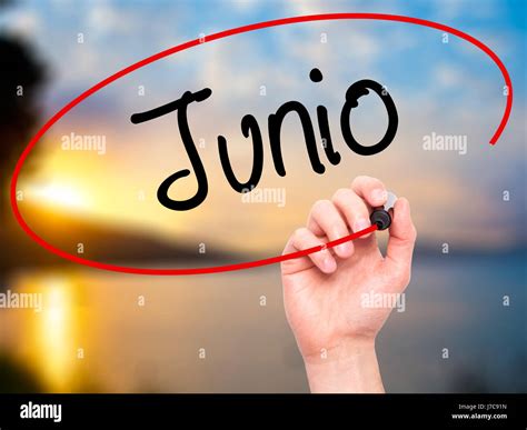 Man Hand Writing Junio June In Spanish With Black Marker On Visual