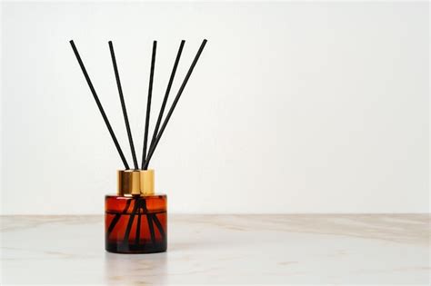 Premium Photo Black Reed Diffuser Bottle On Marble Tabletop