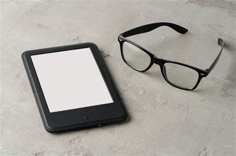 Premium Photo Ebook Reader With Glasses On Gray Background Close Up