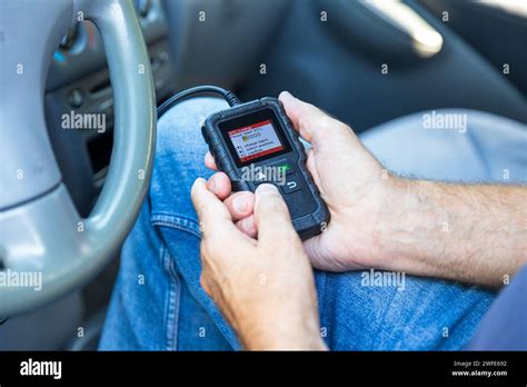 Using Diagnostic Car Code Reader To Erase Error Codes And Turn Off Check Engine Light Stock