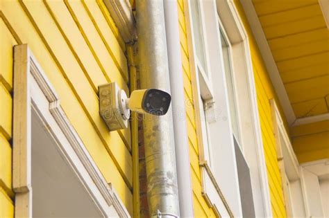 Cctv Security Camera Operating On Yellow Color Wooden Building Stock