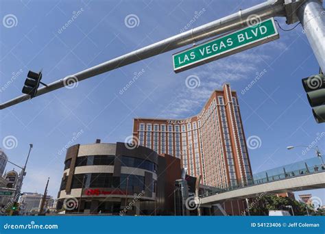 A Las Vegas Boulevard Sign With The Treasure Island Hotel In The