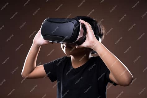 Premium Photo Boy Using Virtual Reality Simulator While Standing