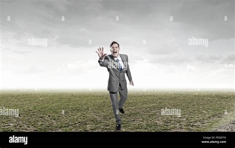 Young Businessman Running And Tryinhg To Catch Up With Something Stock