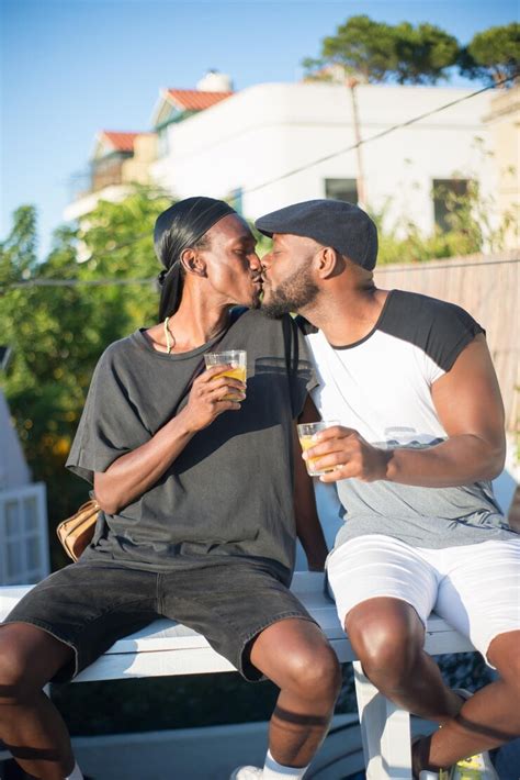 Free Photo Portrait Of Happy African Gay Couple Kissing On Bench Two Men In Casual Clothes
