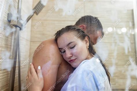 Young Guy And A Girl Take A Shower Together In An Embrace 이미지