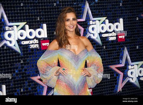 Singer Cheryl Poses For Photographers Upon Arrival At The Global T